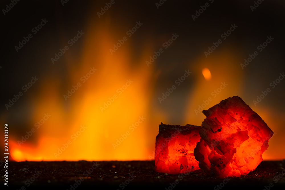 Red hot coal bars in focus on dark background with flames. Background ...