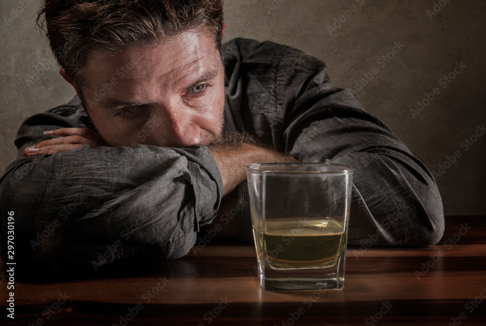 desperate alcoholic man . depressed addict isolated in front of whiskey ...