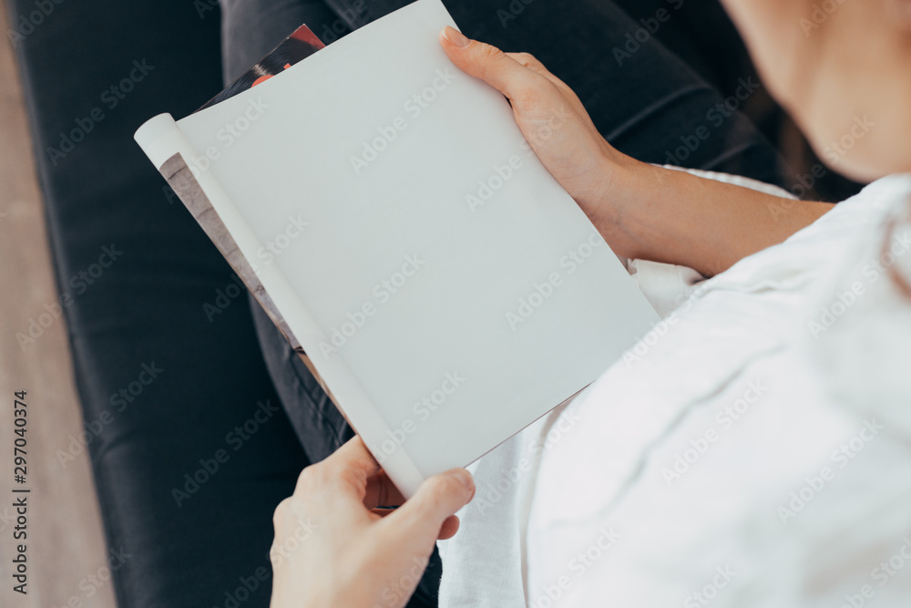Beautiful female hands hold an open book or magazine in the room Stock ...