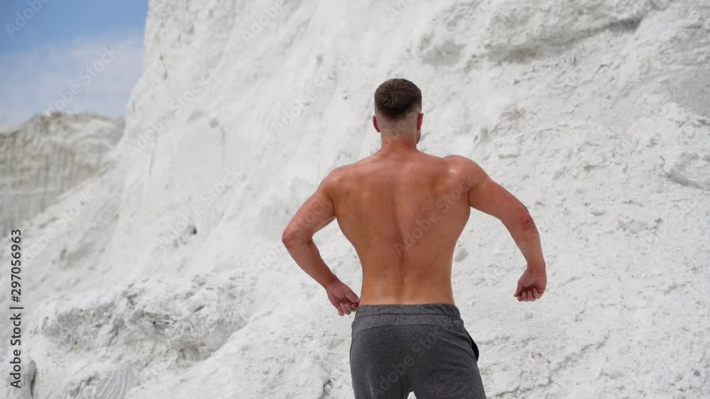 Back view of athlete with muscular body outdoors. Healthy body of a ...