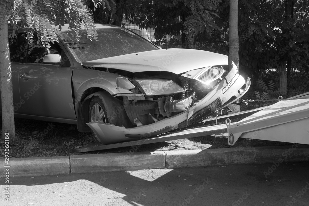 car accident, head-on collision. Tow truck loads a wrecked car after an ...