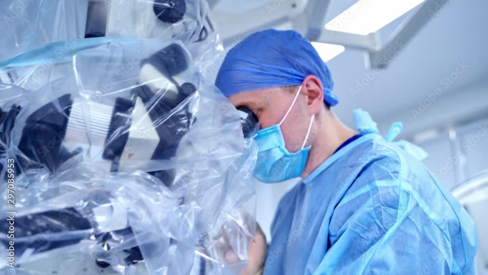 Doctors observe the patient's body through a microscope. Neurosurgery ...