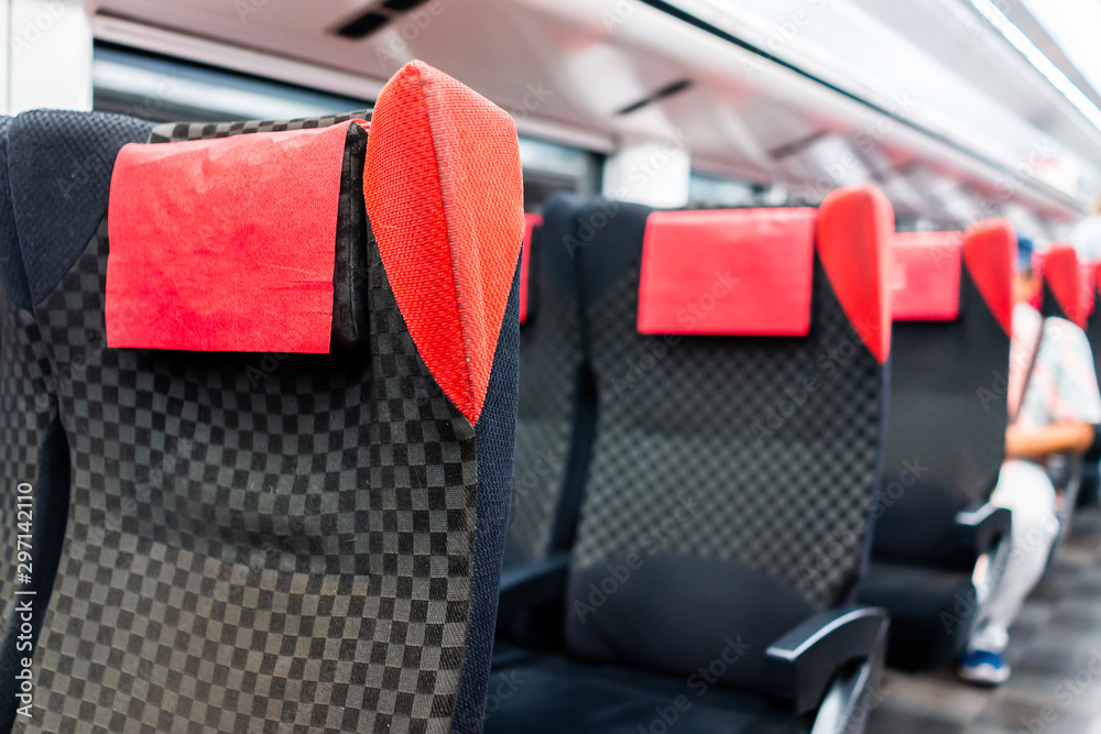 Empty red comfortable chairs seats row closeup in aisle in subway train ...
