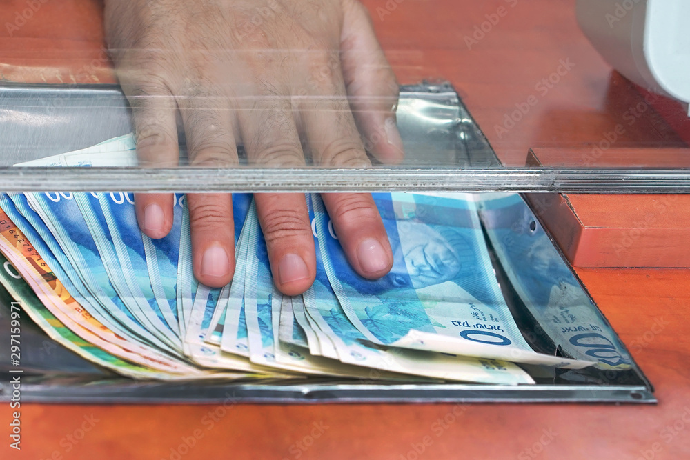 Cash money israeli shekel, at bank office or currency exchanger. Male ...