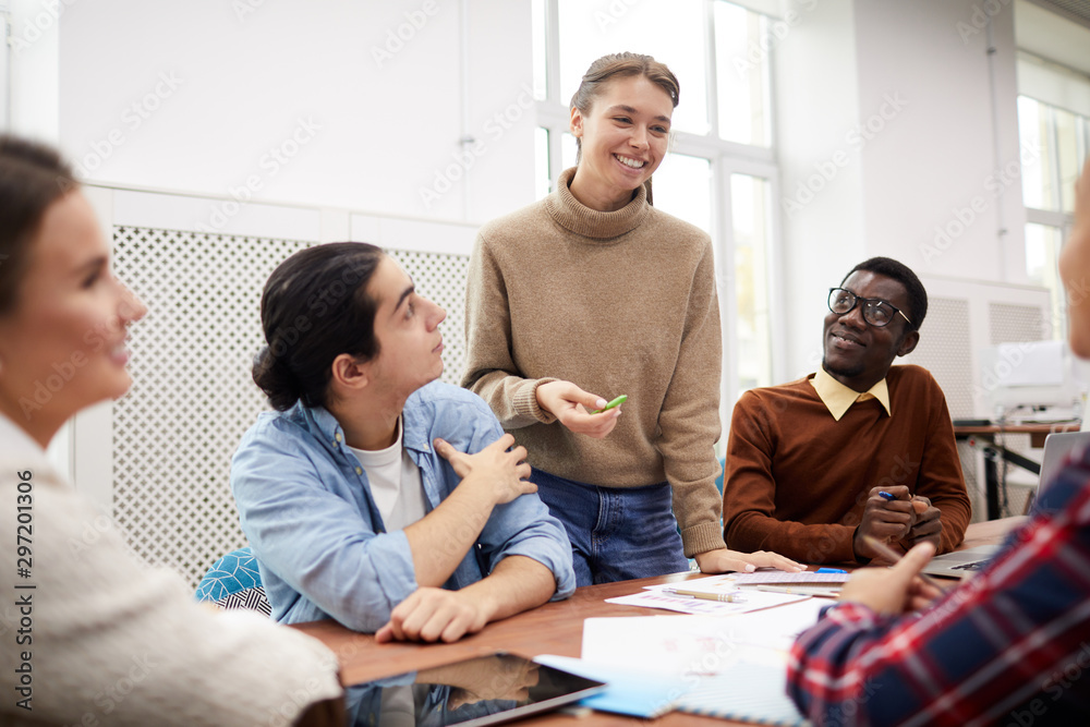 Large group of students working together on team project while studying ...