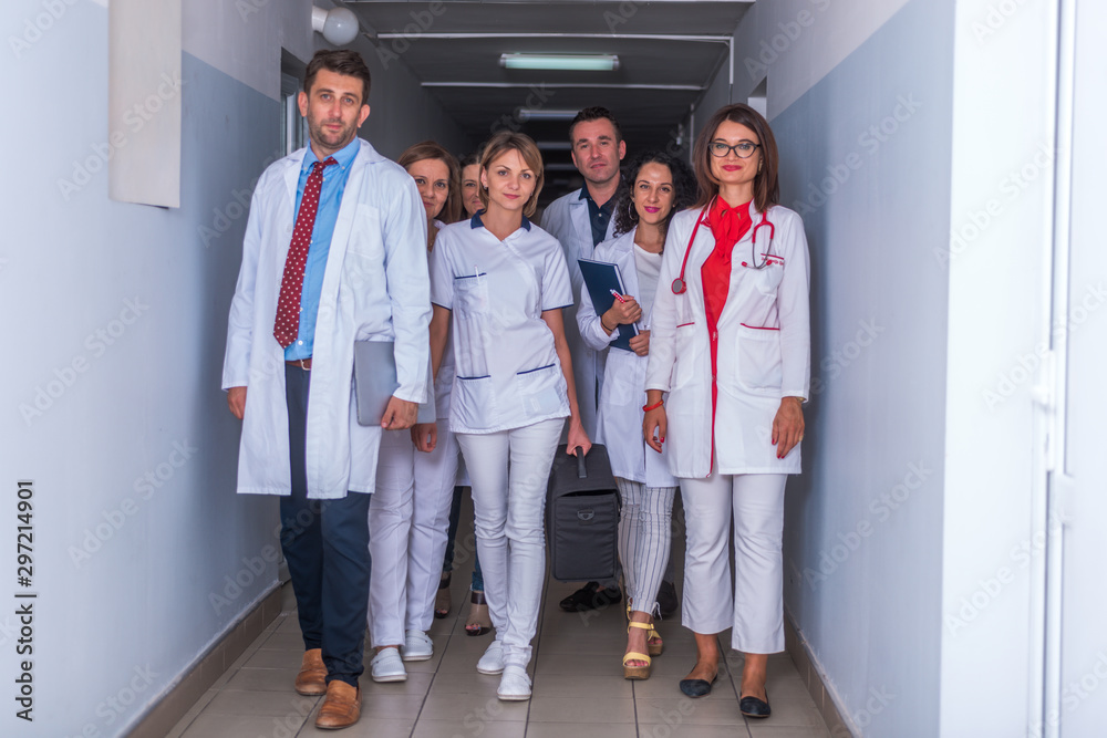 Group of medical staff, team doctors and nurses posing in the hallway ...