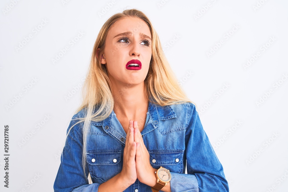 Young beautiful woman wearing casual denim shirt standing over isolated ...