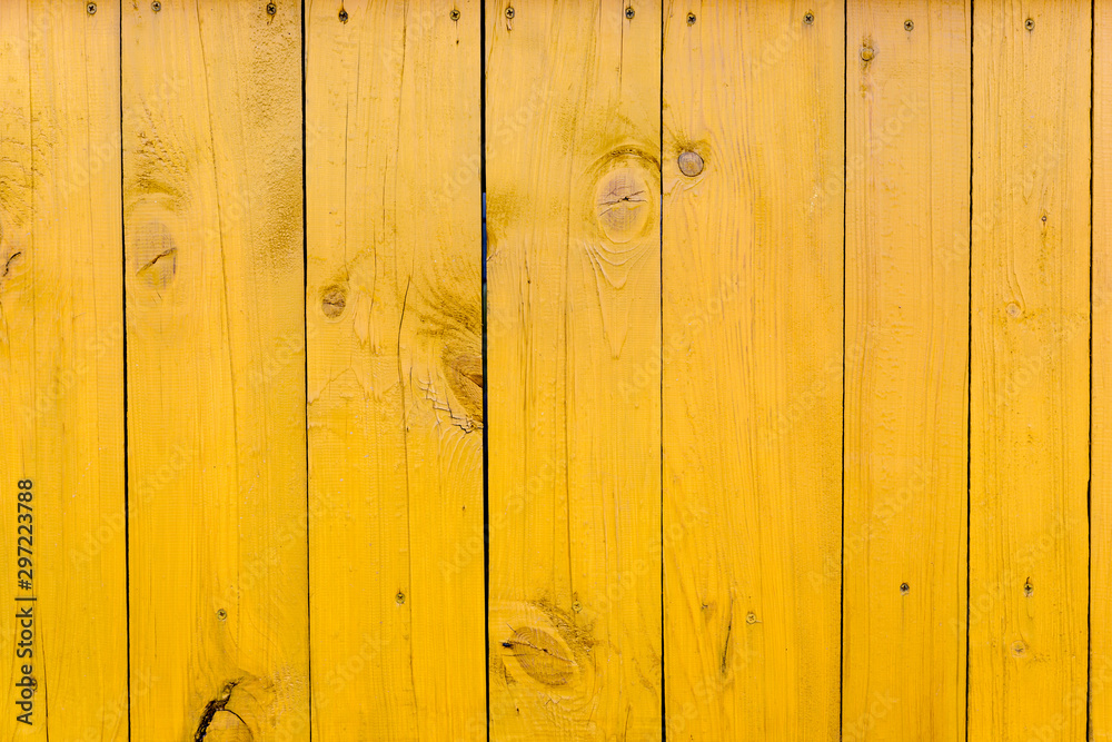 Background of wooden narrow vertical boards of bright yellow color ...