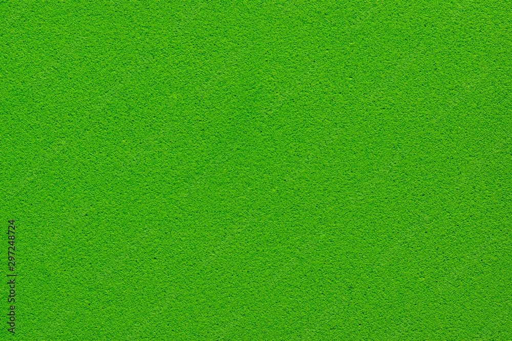 Plain green background of Kelly hue. Close up image of a rubber mat ...