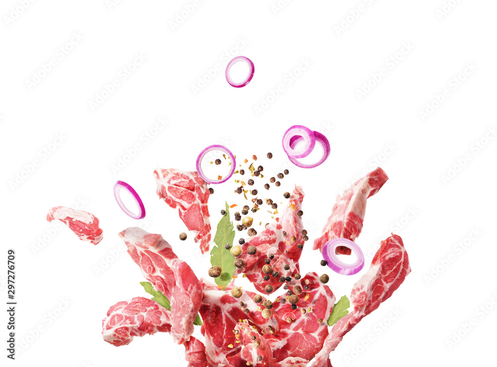 Cooking concept. Pieces of raw meat fly out of screen border on a white ...