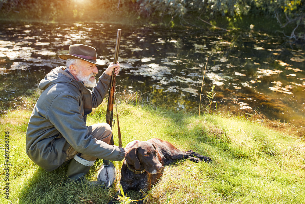 Resting after hunting. Good job, successful hunting on lake. Bearded ...