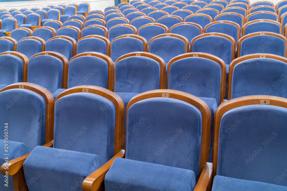 Blue plush chairs in the auditorium of the theater. The interiors of ...