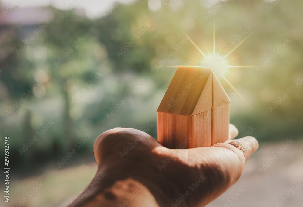 house from wooden block in human plam with blur background Stock Photo ...