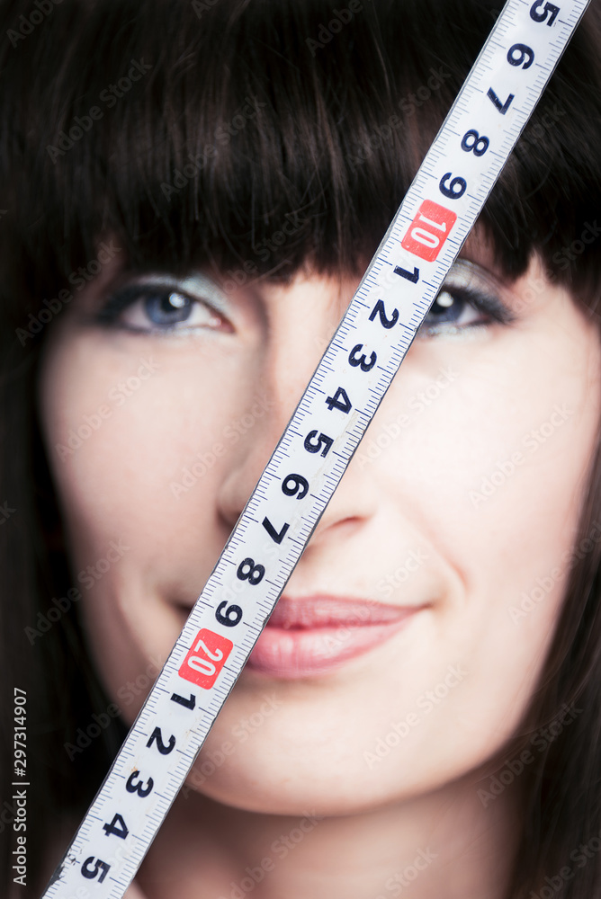 Beauty Standards concept - Measuring tape cuts diagonally in front of ...