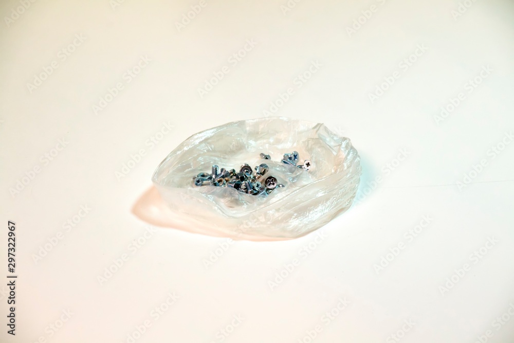 Short bolts and nuts in a plastic bag white background Stock Photo ...
