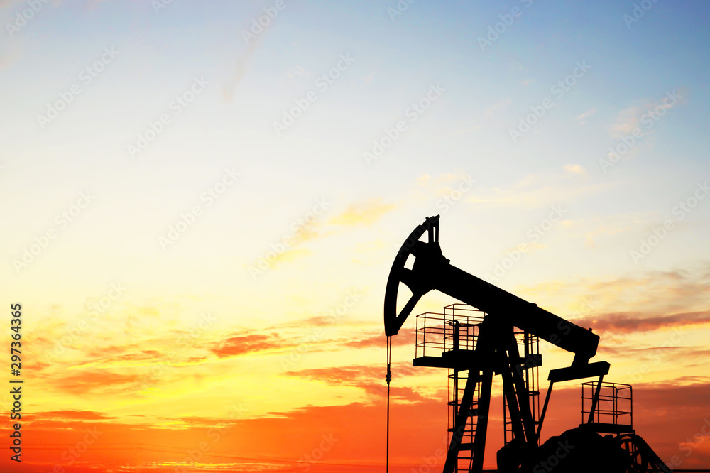 Oil drilling derricks at desert oilfield. Crude oil production from the ...