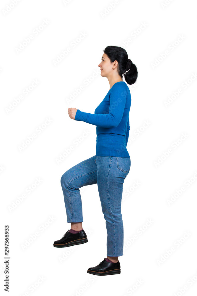 Full length side view of motivated, confident young woman climbing a ...