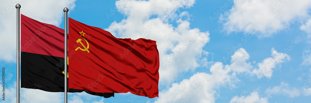 Angola and Soviet Union flag waving in the wind against white cloudy ...