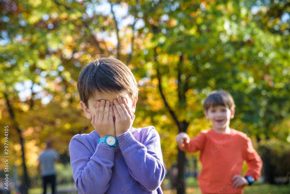 Pupil bullying another in the yard at the elementary school. Older boy ...