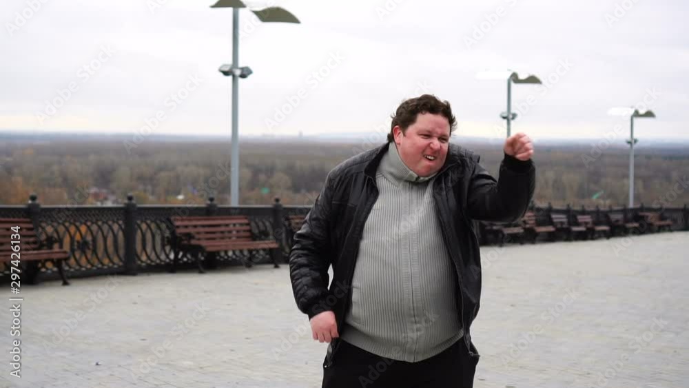 Zoom in portrait of fat man with big belly is dancing outdoor. Stock ...