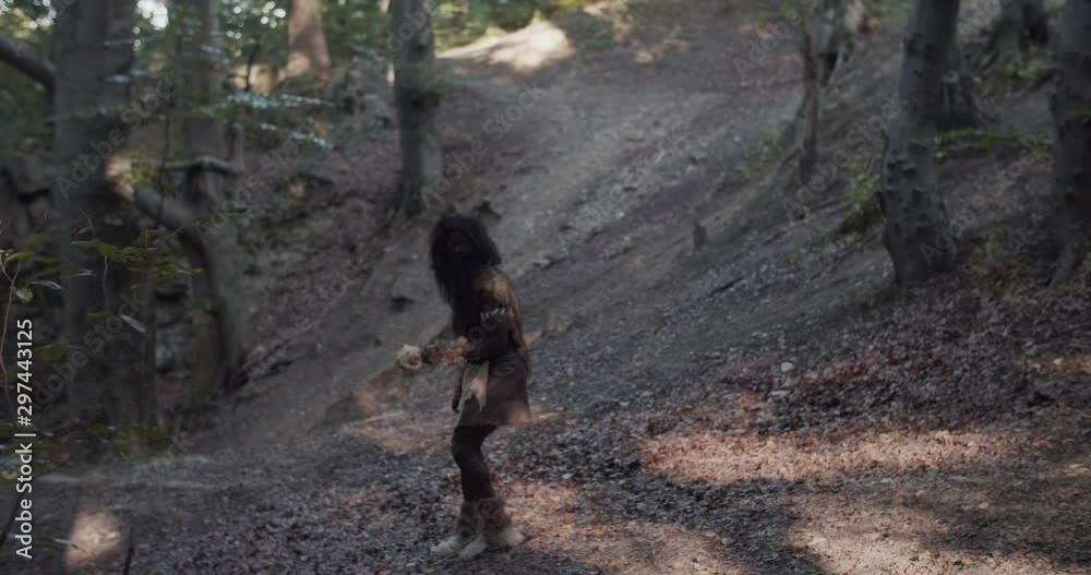 Primeval black caveman holding weapon neanderthals wearing animal skin ...