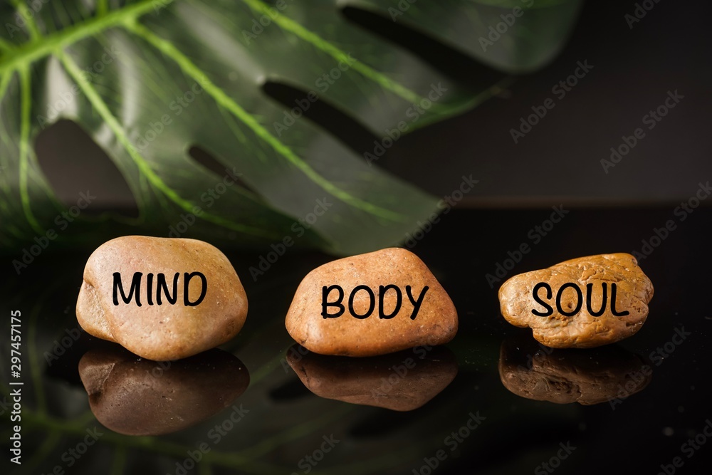 Zen Concept: Mind, Body and Soul wordings on stones against black ...