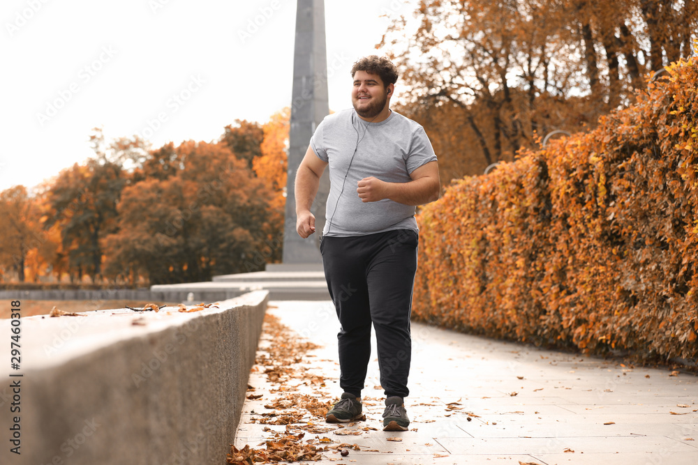 Young overweight man running in park. Fitness lifestyle Stock Photo ...