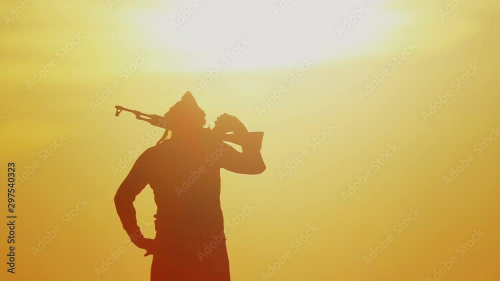 warrior with Kalashnikov at sunset day. fighter is training with a ...