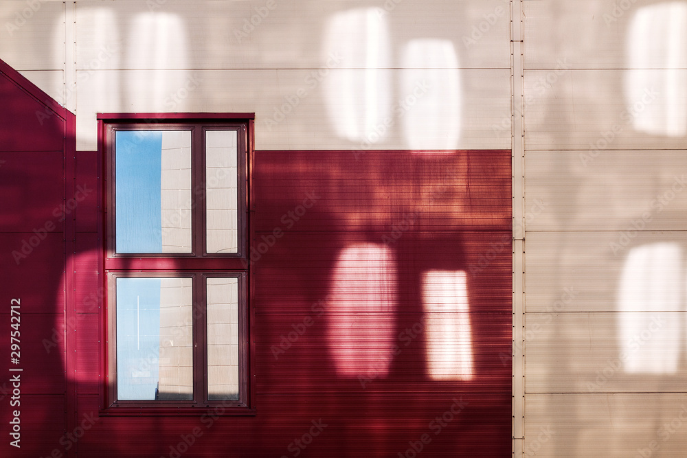 Stockfoto facade of a red-yellow building with reflections from the ...