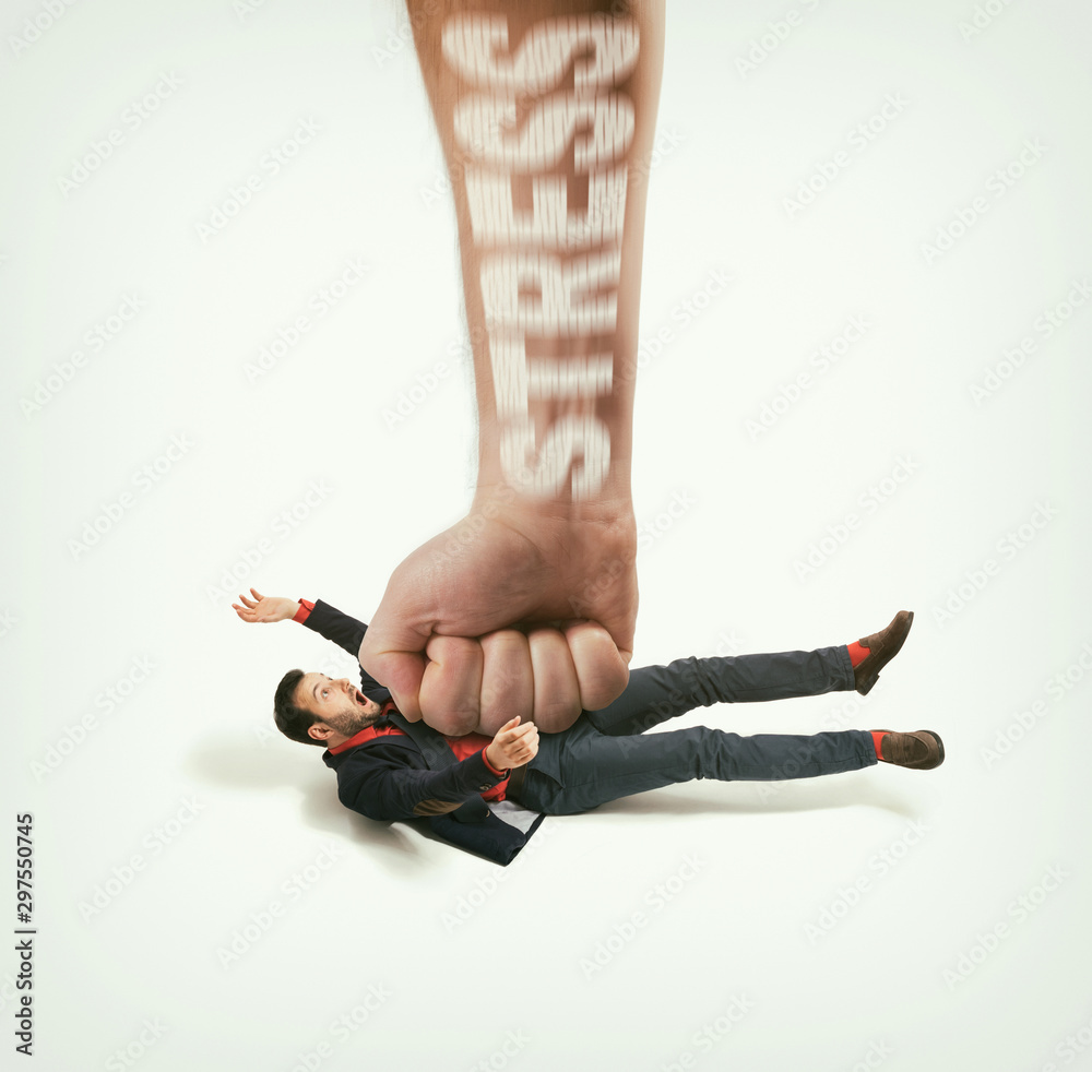 The big human fist with text - stress bring down the man off his feet ...