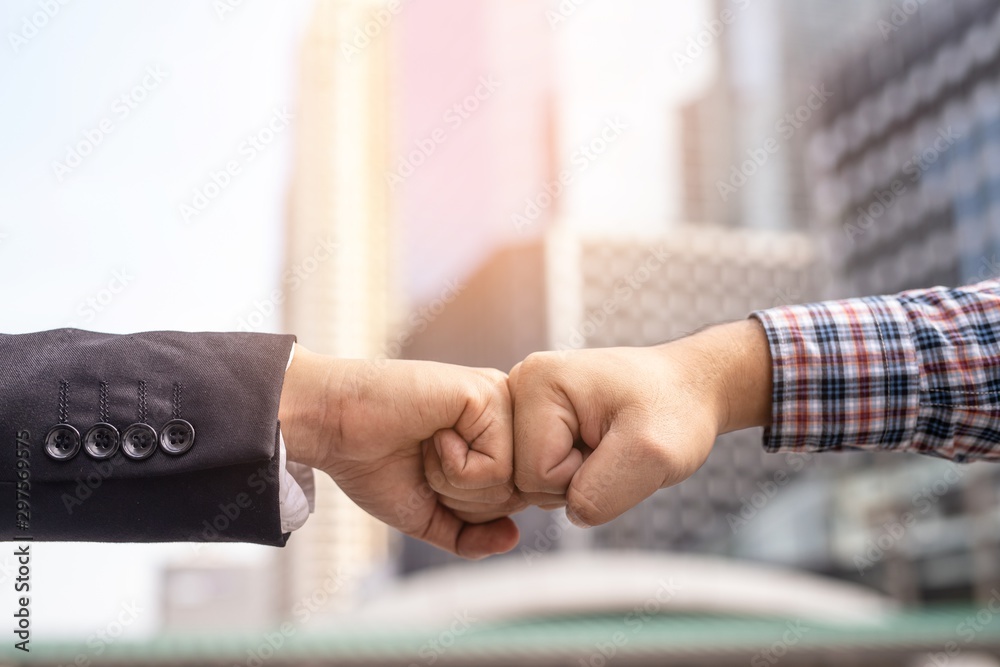 Image of businessman making a fist bump on building Stock Photo | Adobe ...