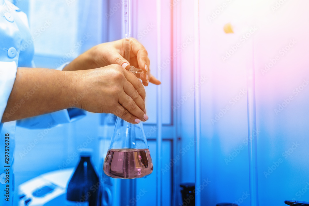 Laboratory beaker in test, chemical reaction. Lab worker checks ...