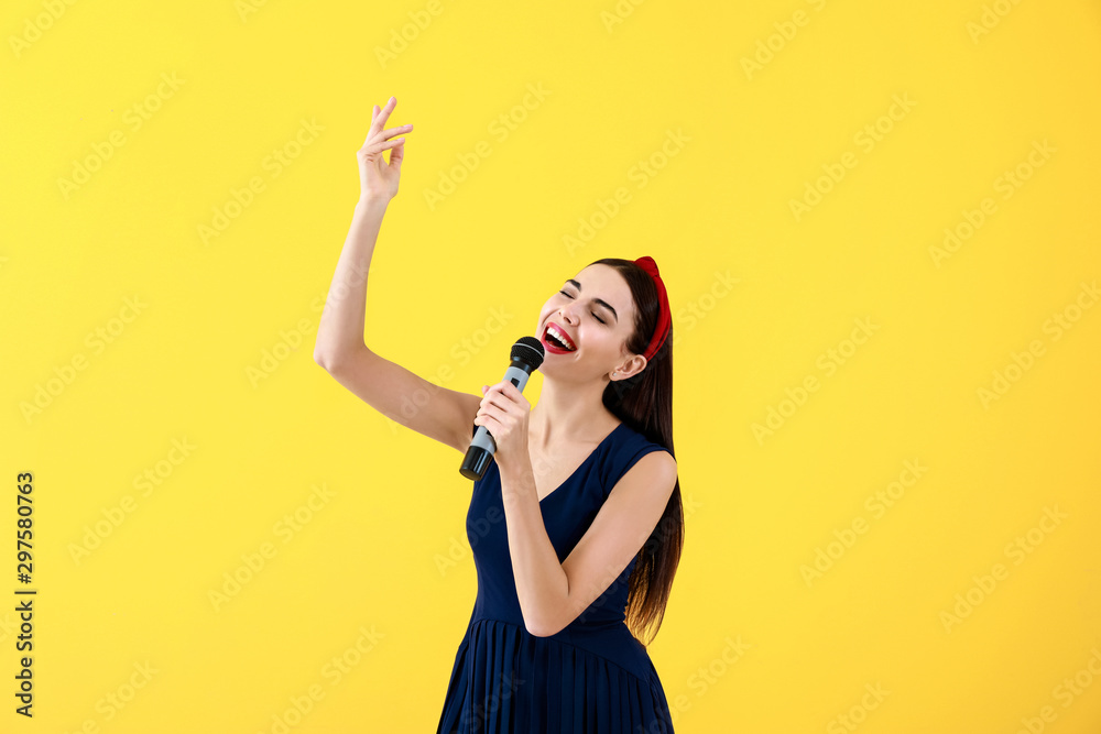Beautiful young female singer with microphone on color background Stock ...