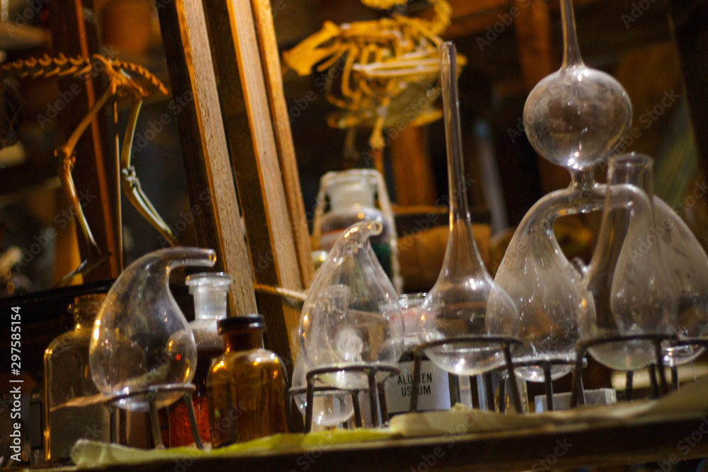Set of alchemy bottles in laboratory of alchemist. Herb in old pots ...