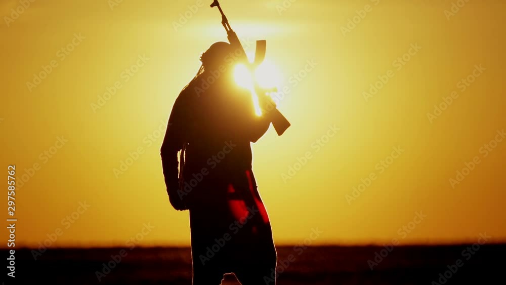 warrior with Kalashnikov at sunset day. fighter is training with a ...