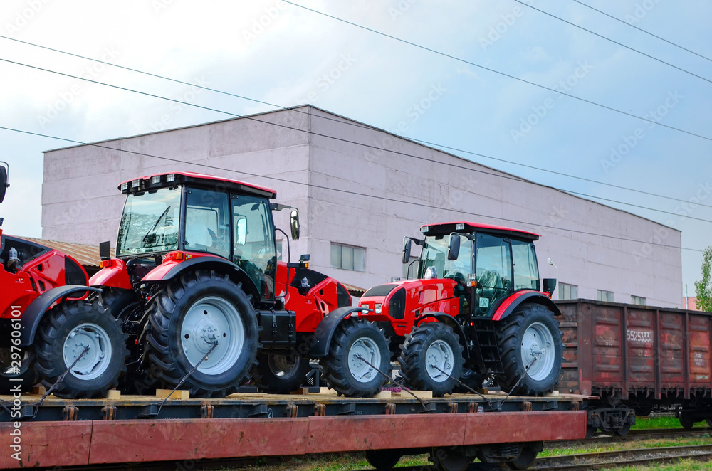 Farm tractors loaded on a freight train. Import/export of the ...