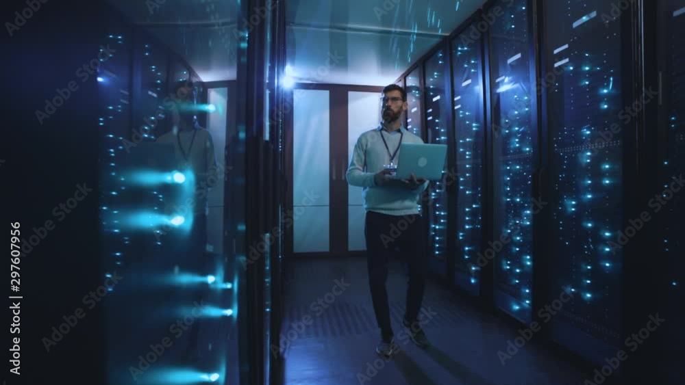 Server engineer walking in cloud computing data center. Caucasian IT ...