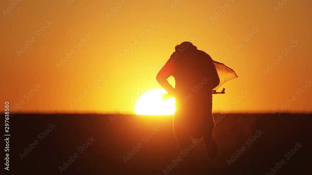 Islamic warrior with Kalashnikov at sunset day. Muslim fighter is ...