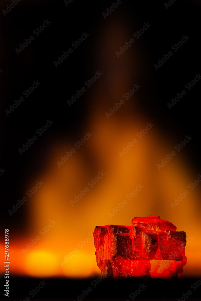 Red hot coal bars in focus on dark background with flames. Background ...
