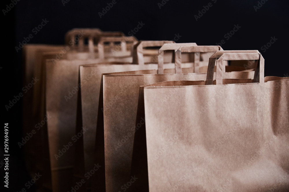 Brown paper bags on a black background Stock Photo | Adobe Stock