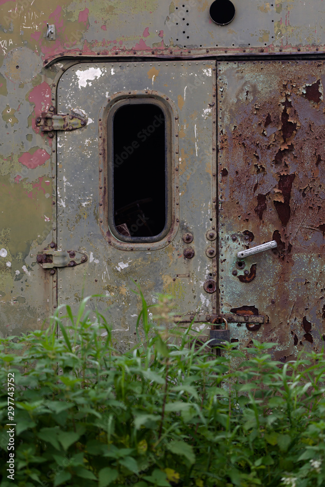 Rusty scratched metal texture of trailer carcass with craced window ...