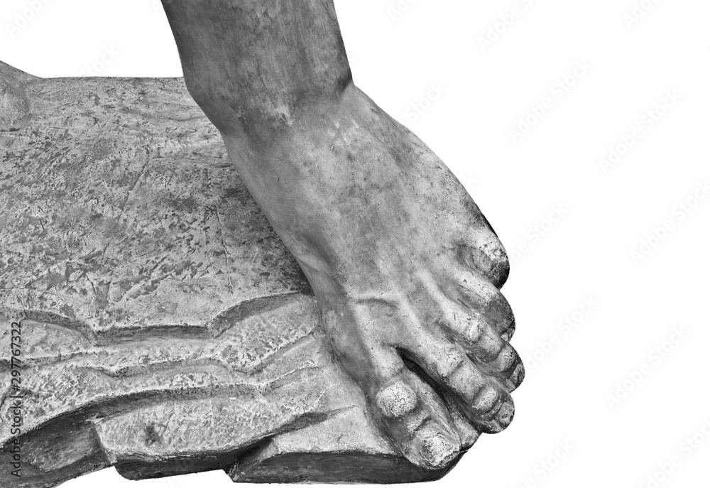 Foot. Fragment of an antique marble statue. Cracked ground in the ...