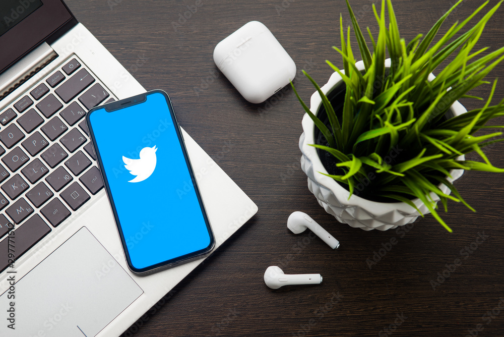 Twitter logo on the iphone X screen is placed on the laptop keyboard ...