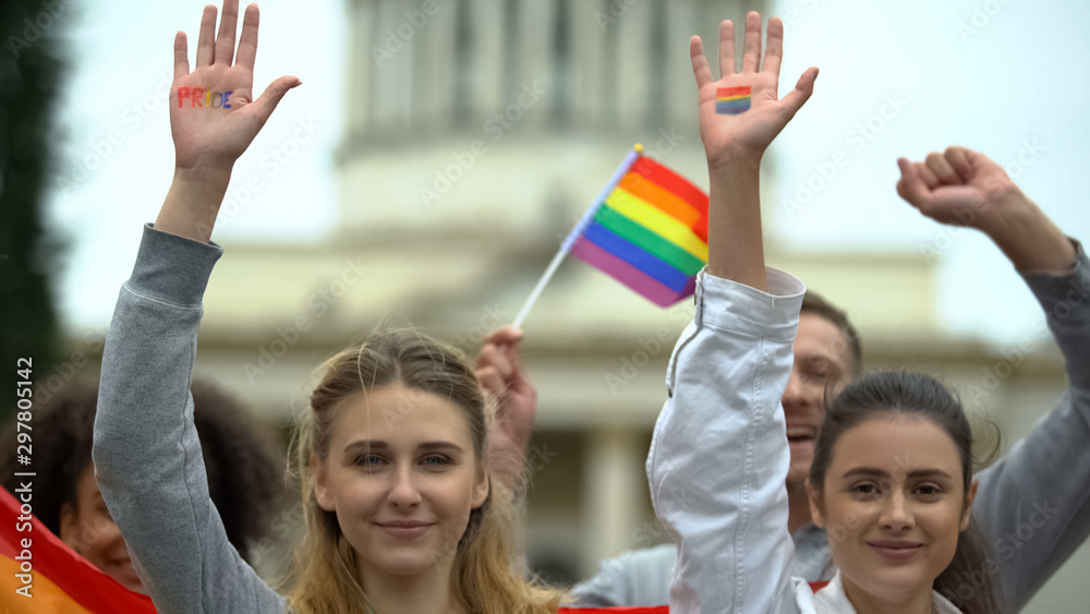 Activists chanting LGBT slogans, showing painted rainbow symbols on ...