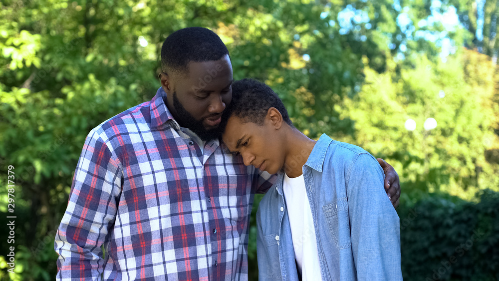 Kind father hugging teenage son admitting guilt, child upbringing ...