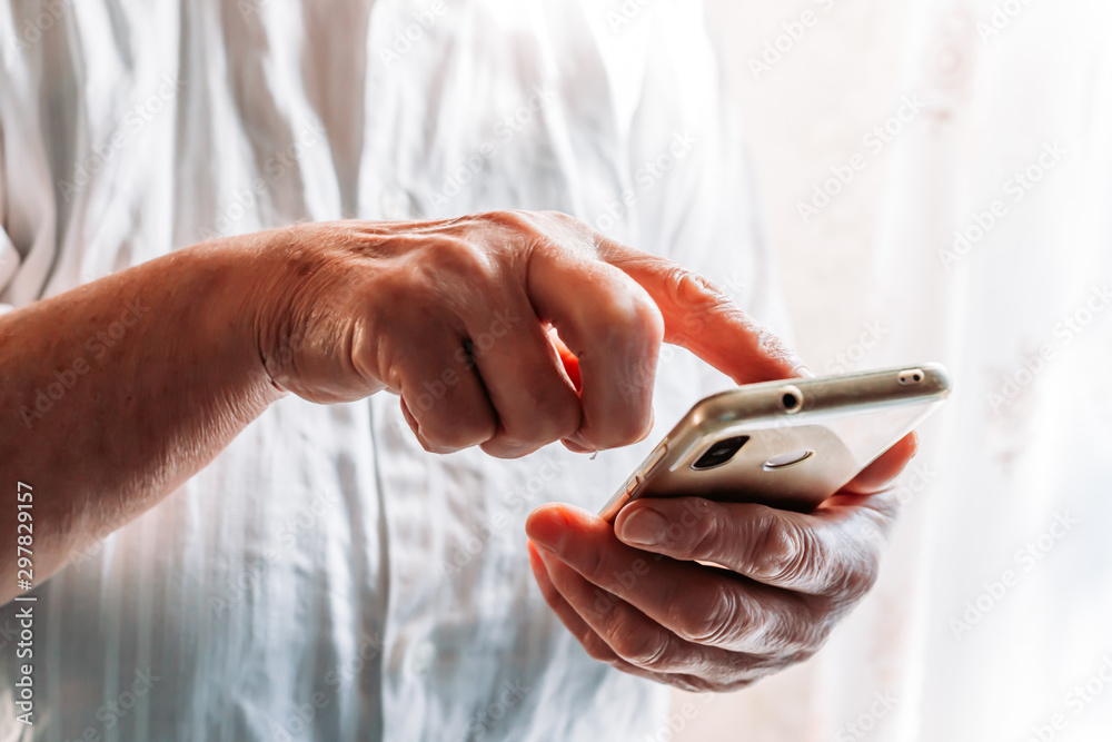 Older woman hands. Using touch screen phone. Old people and technology ...