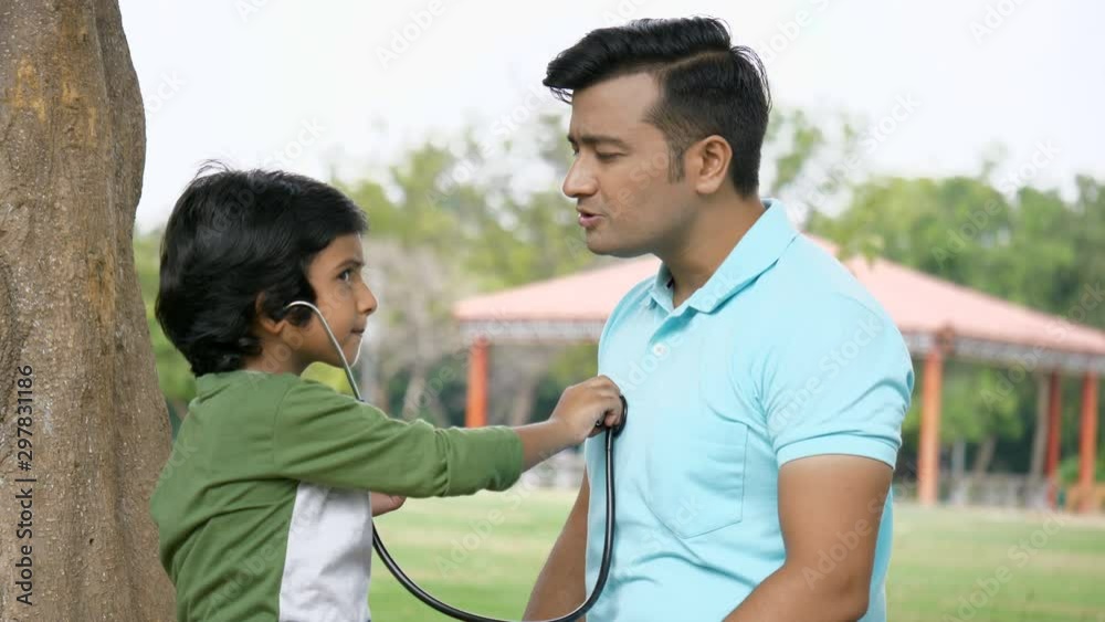 Cute little child playing doctor-doctor with his dad - Doctor's role ...