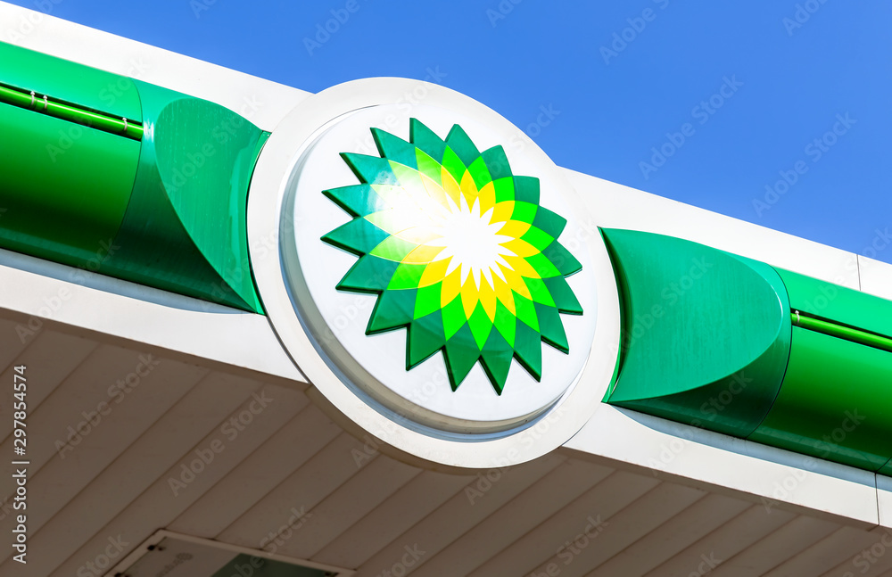 BP - British Petroleum petrol station logo over blue sky Stock Photo ...
