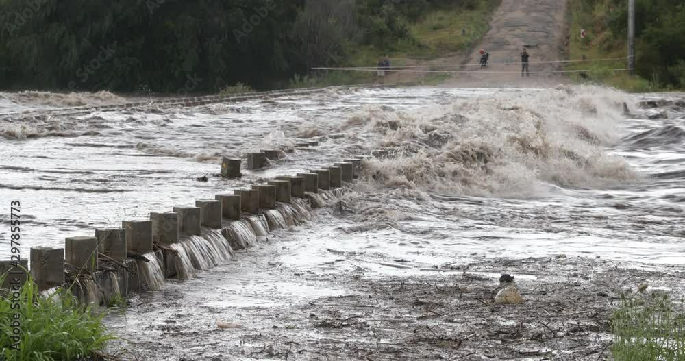 Strong river passing over bridge. Turbulent violent water flow over ...