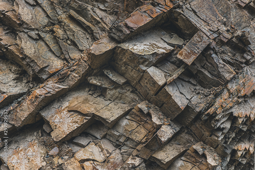 Layers and cracks in sedimentary rock on cliff face, background. Cliff ...